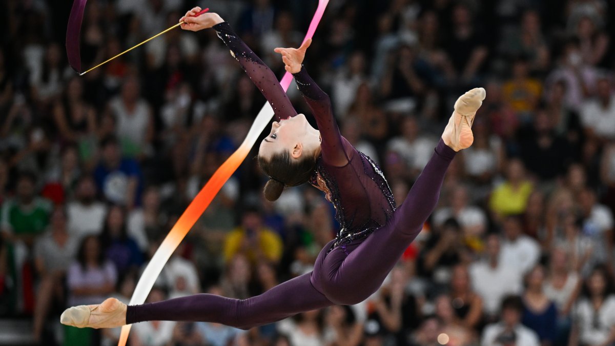 Flip through how artistic and rhythmic gymnastics differ at the ...