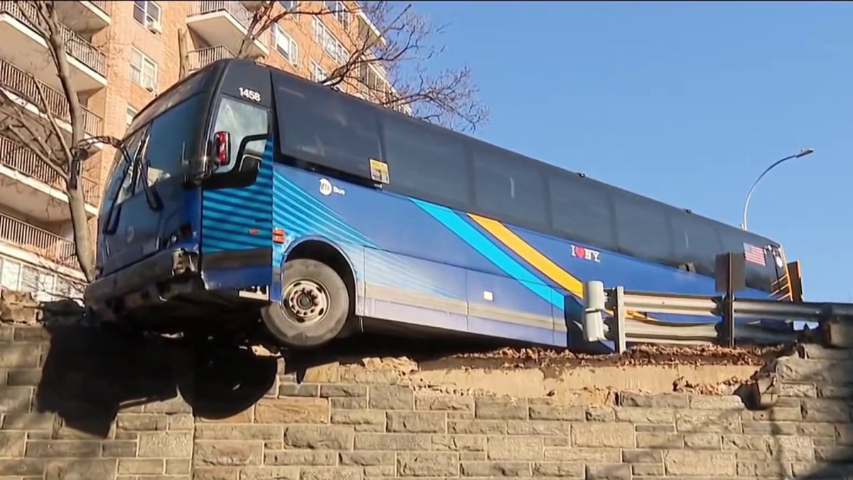 Bus left hanging off Bronx roadway after crashing through wall – NBC ...